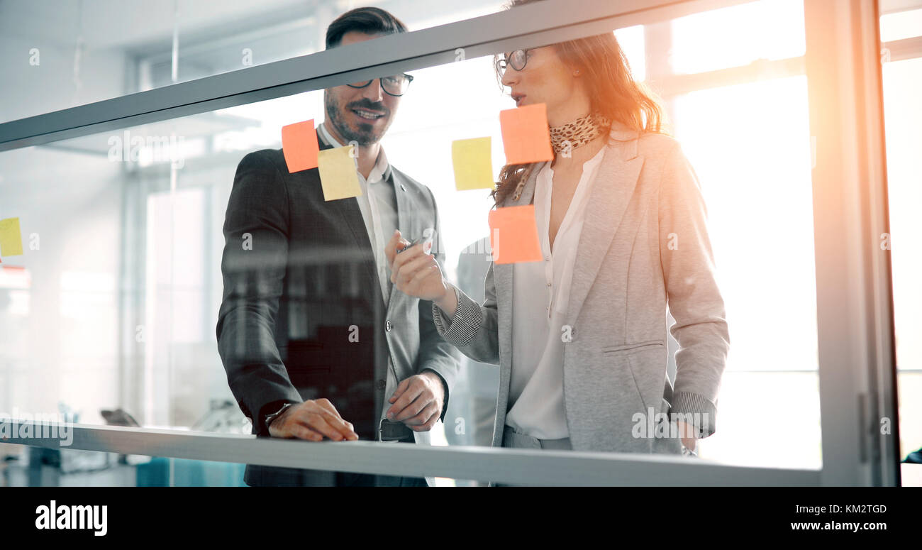 Businesswoman using sticky notes at office to plan project Stock Photo ...