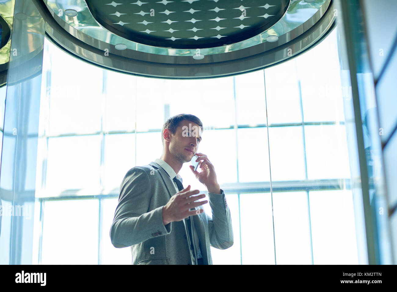 Handsome Businessman Speaking by Phone against Window Stock Photo - Alamy