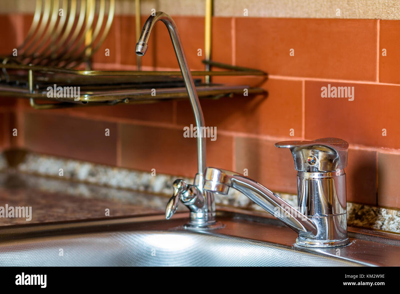 New shiny metal water faucet in modern kitchen Stock Photo - Alamy