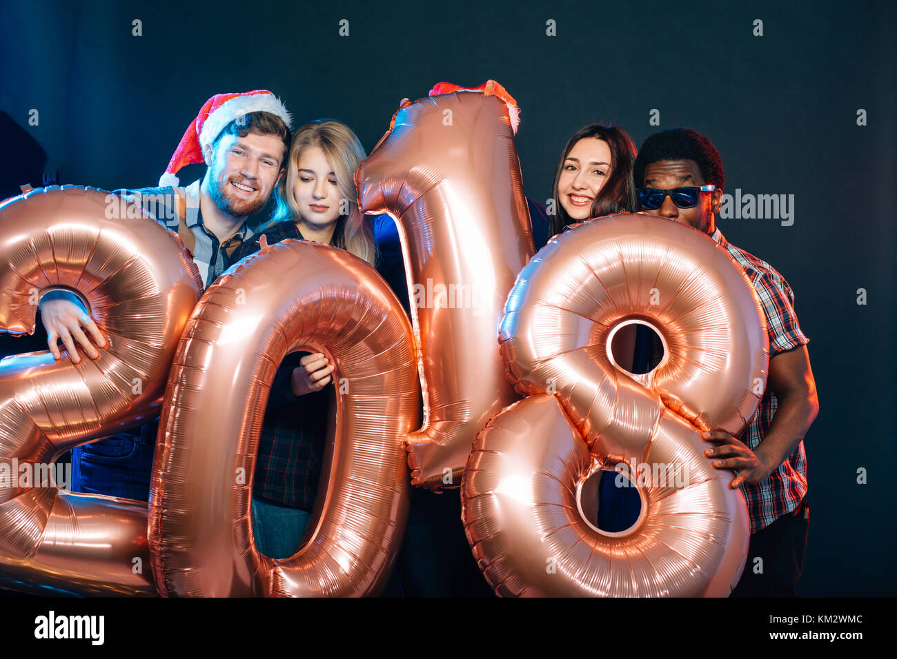 Happy smiling people holding golden number balloons, 2018 year symbol ...