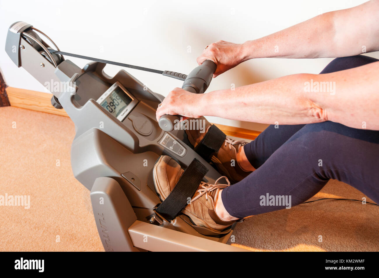 Fitness girl exercising using rowing machine hi-res stock photography ...