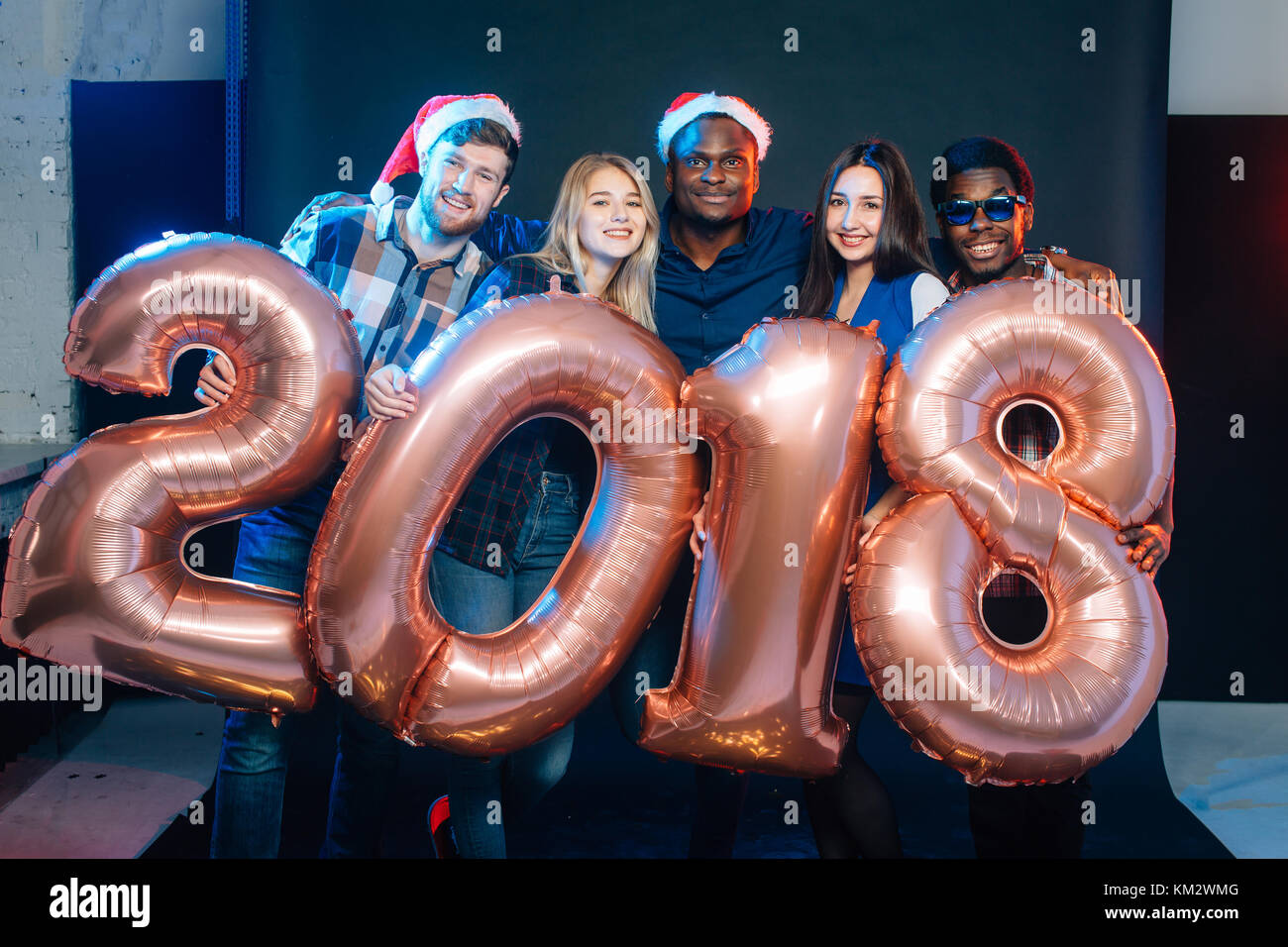 Happy smiling people holding golden number balloons, 2018 year symbol ...