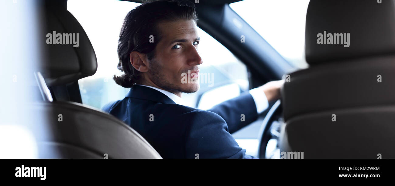 man sitting behind the wheel of a car Stock Photo - Alamy