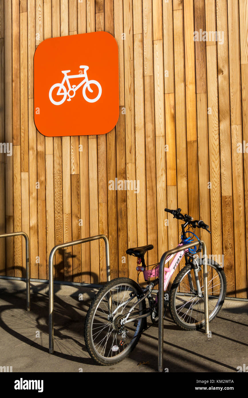 A bicycle rack and sign outside a UK supermarket Stock Photo - Alamy