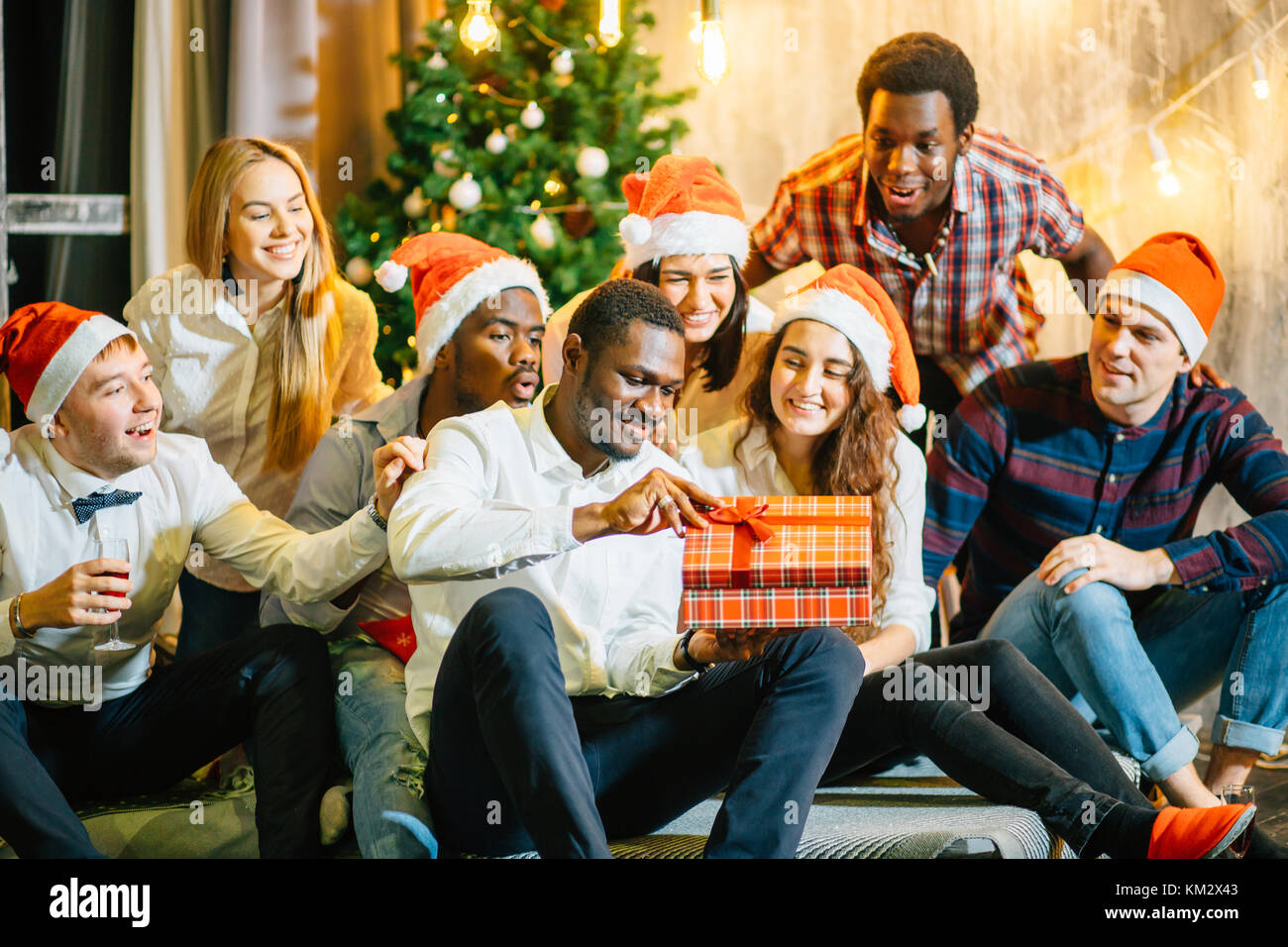 happy smiling friends opening magic Christmas gift Stock Photo - Alamy