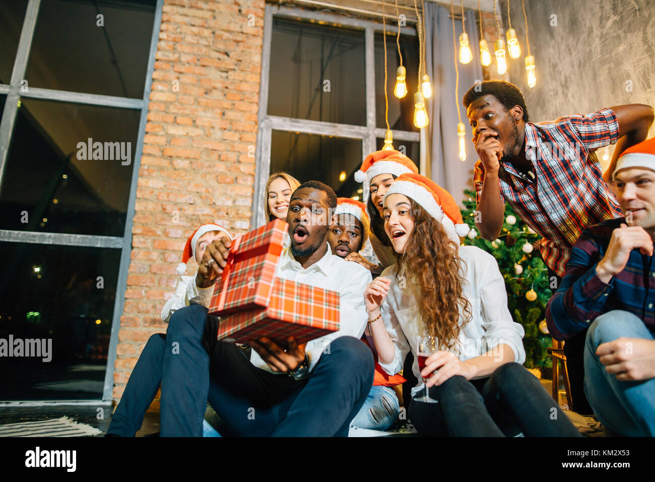happy smiling friends opening magic Christmas gift Stock Photo - Alamy