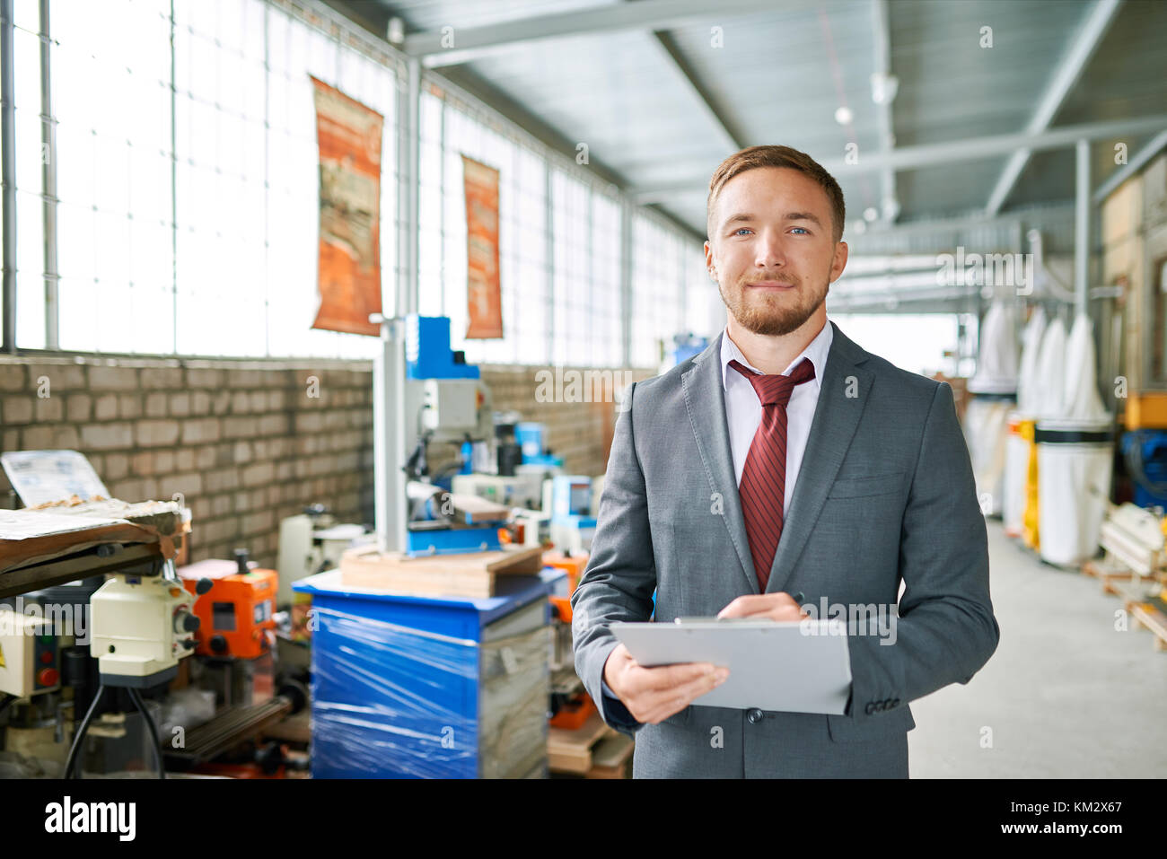 Successful Salesman Posing in Machine Shop Stock Photo - Alamy