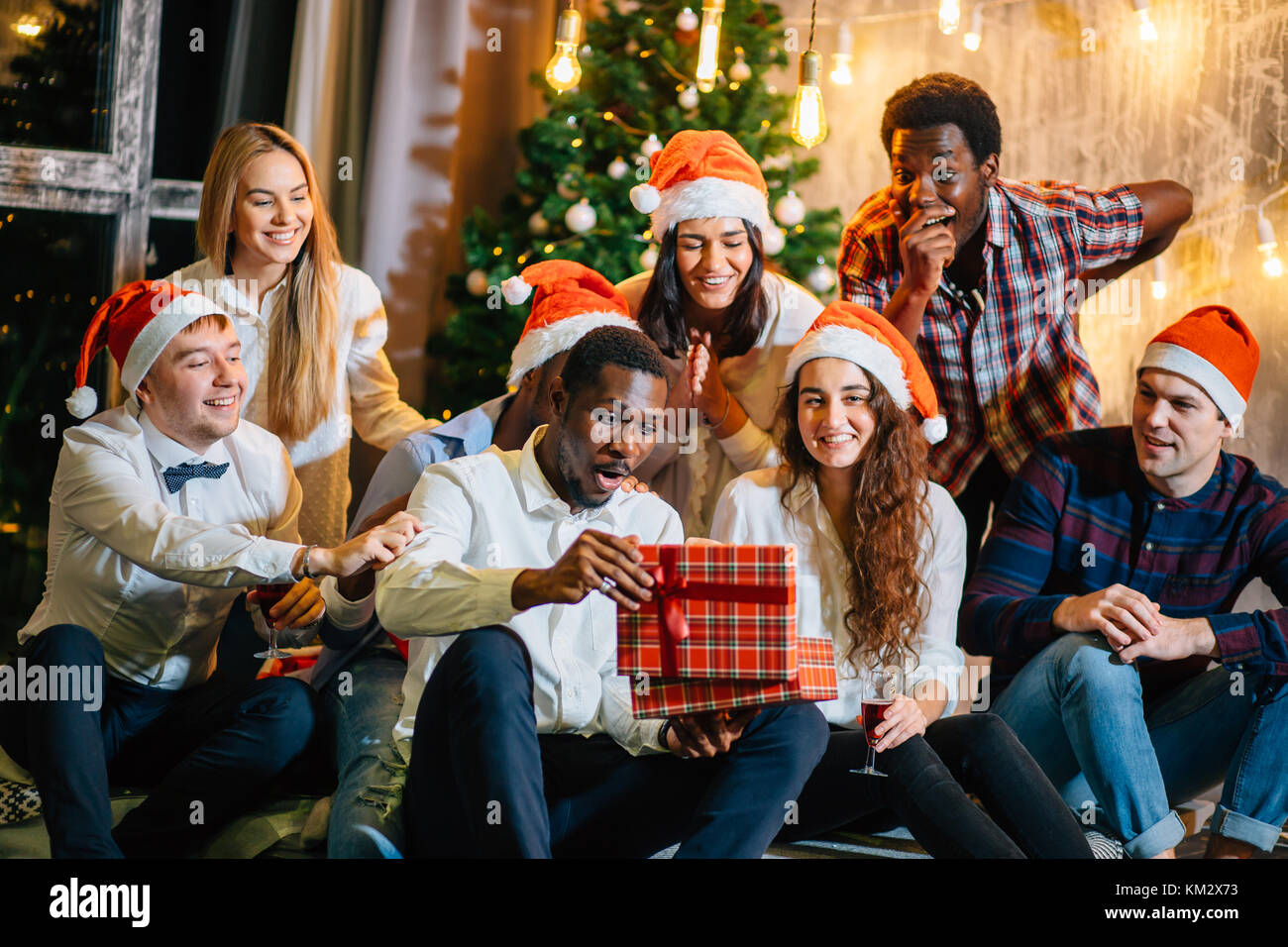 happy smiling friends opening magic Christmas gift Stock Photo - Alamy