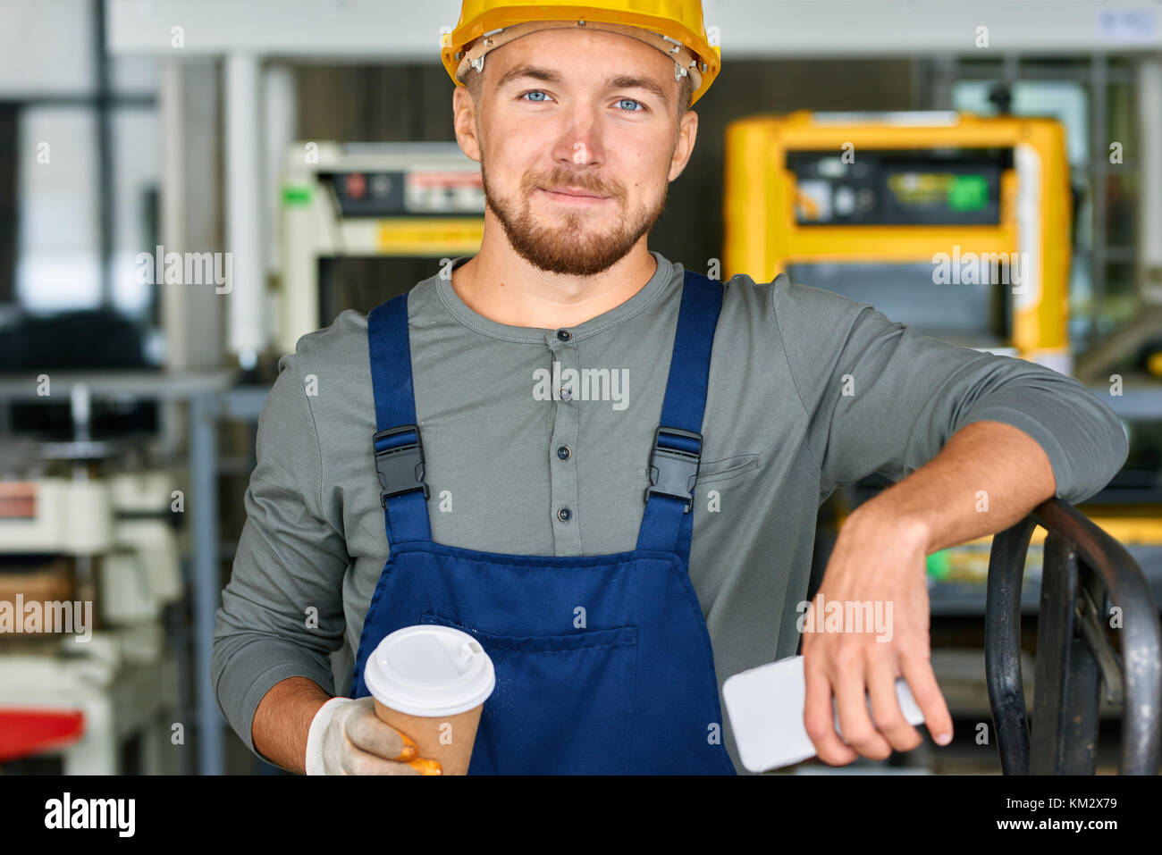 Smiling Young Workman Posing on Break Stock Photo - Alamy
