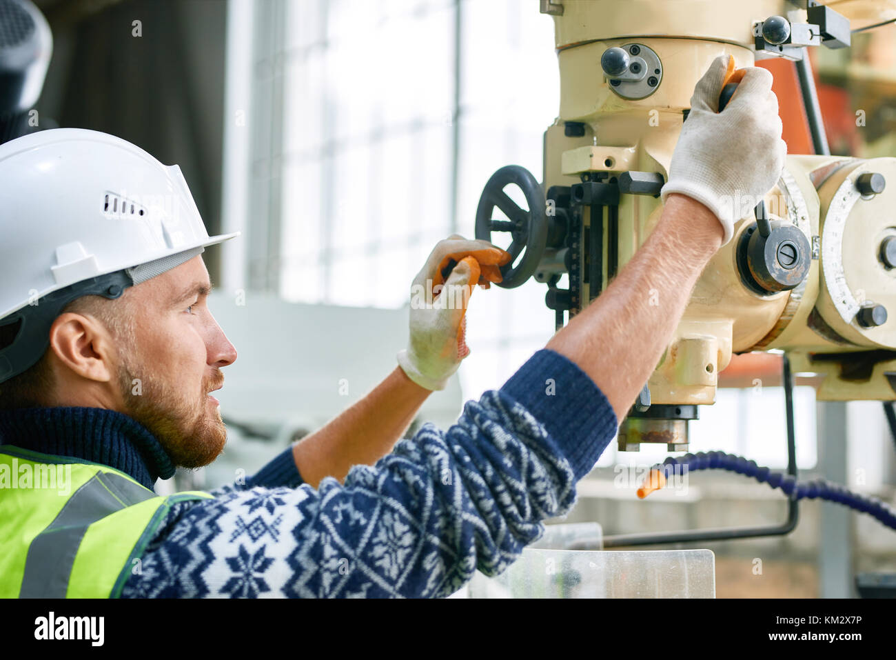 Factory Worker Using Machine Units Stock Photo - Alamy