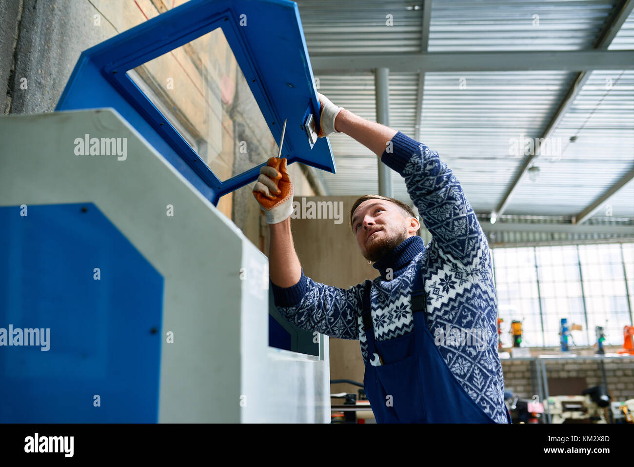 Young repairman fixing industrial hi-res stock photography and images ...