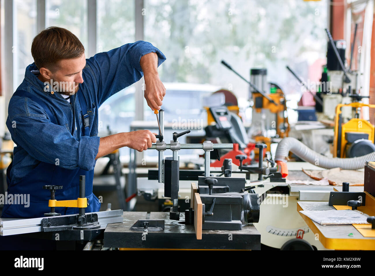 Man Repairing Machines at Factory Stock Photo - Alamy
