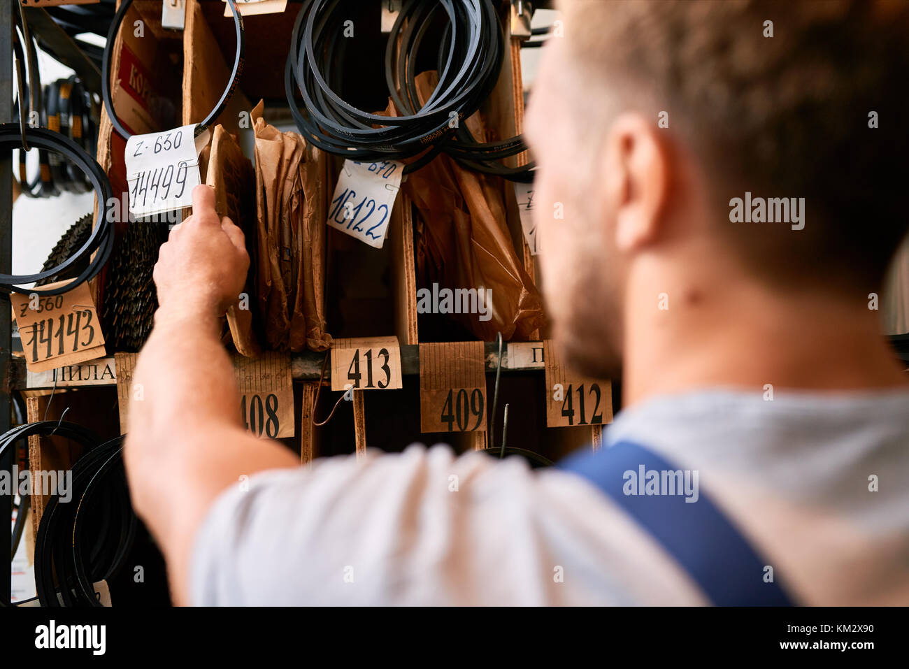 Worker Choosing Parts in Storage Room Stock Photo - Alamy