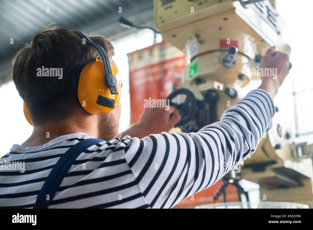 Back View of Worker Operating Machine Unit Stock Photo - Alamy