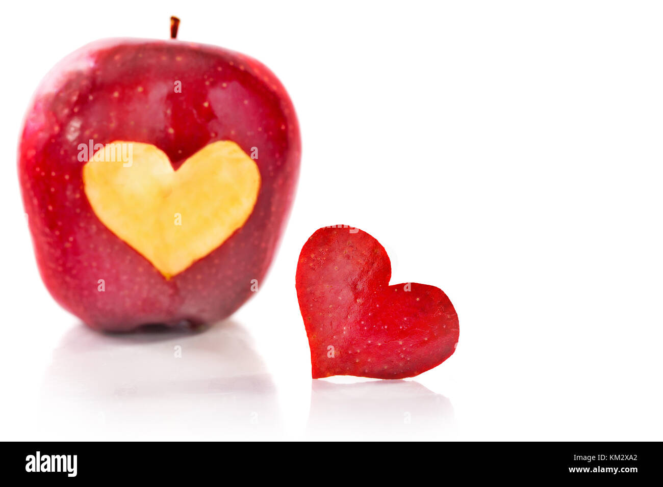 Red apple and the heart which is cut out from apple. A close up ...