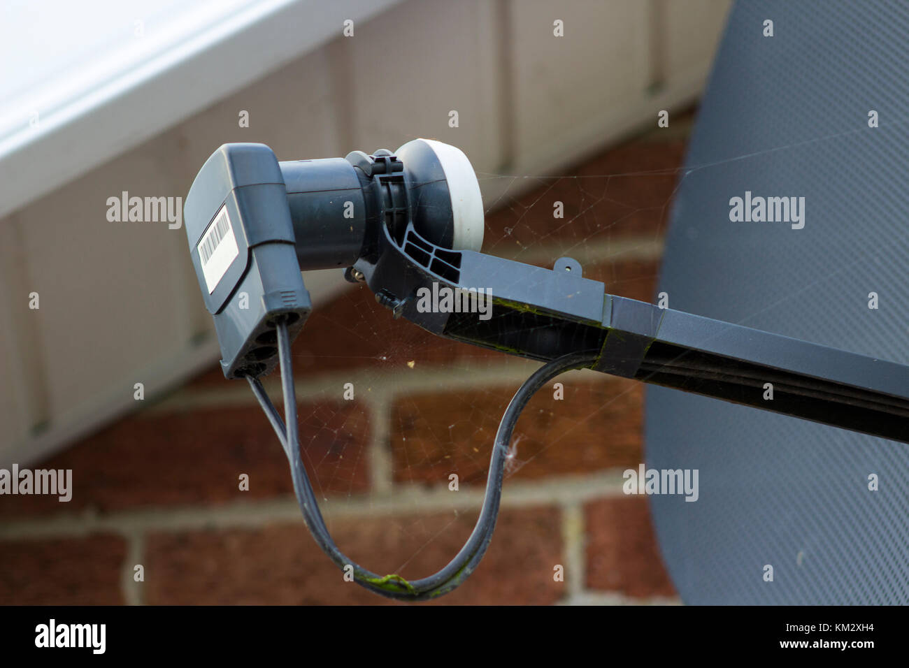 A domestic satellite tv installation under the eaves of a home in the ...