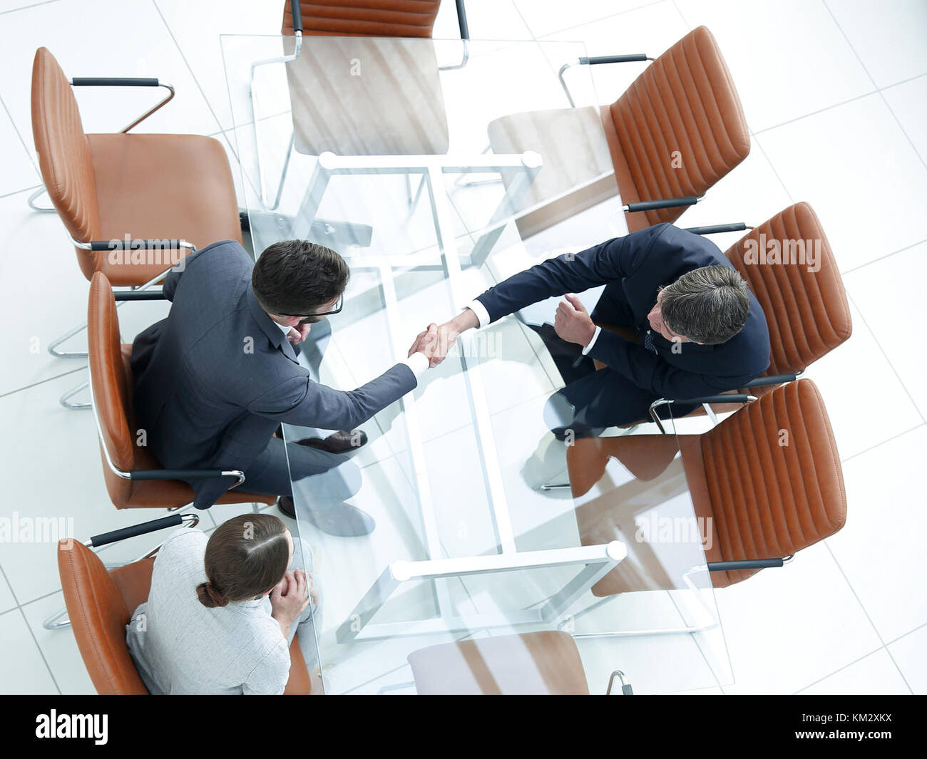 Handshake across the table. Meeting around a boardroom table Stock ...