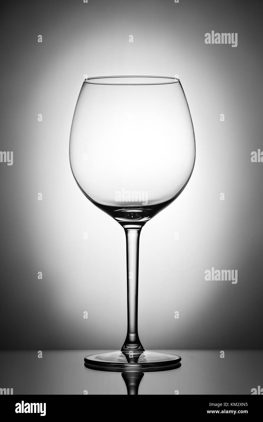 One empty wineglass for red wine on diffusion lit background ...