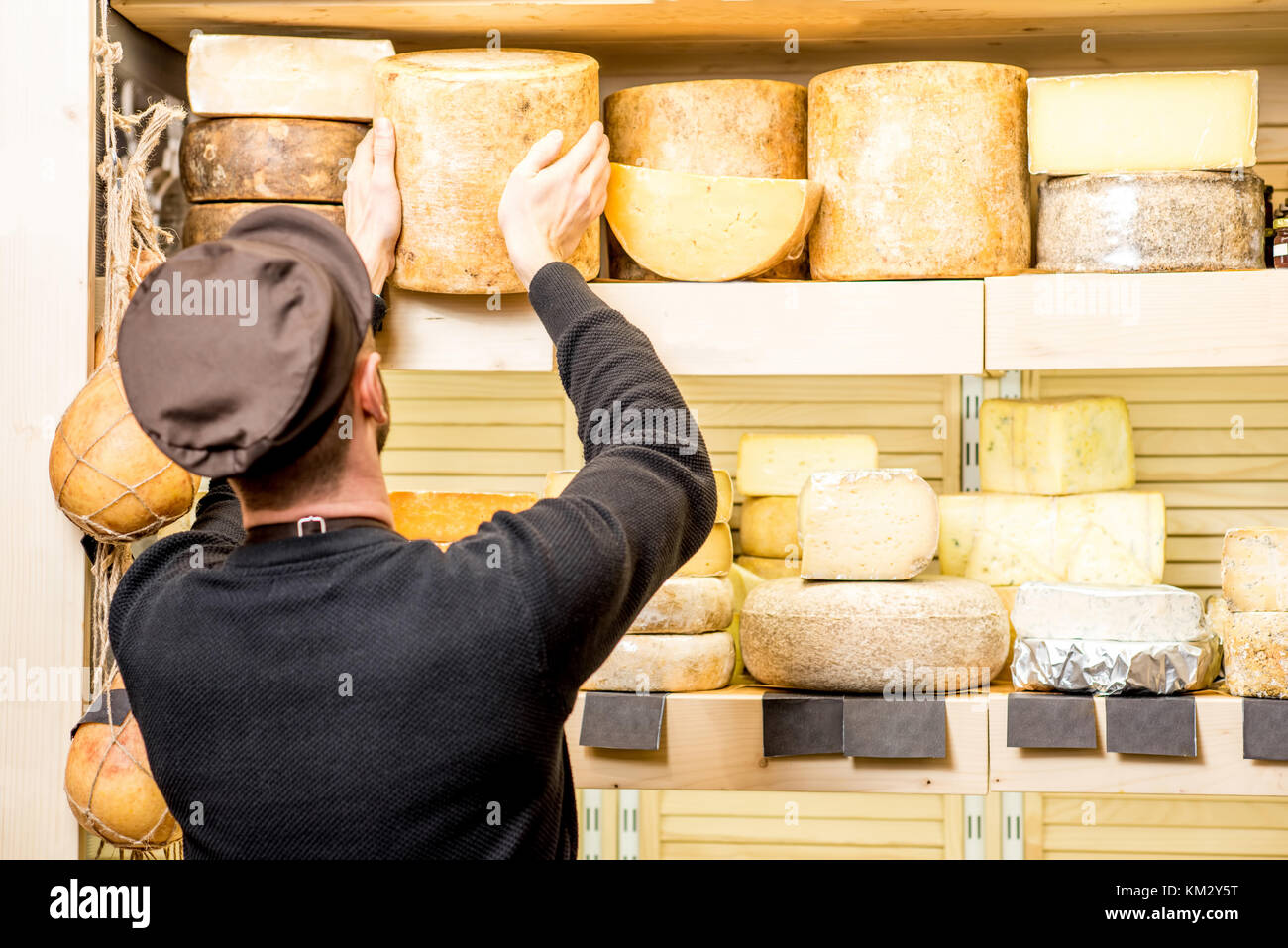 Cheese seller at the shop Stock Photo - Alamy