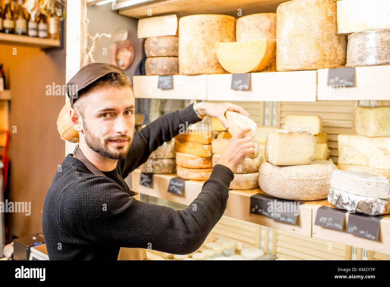 Cheese seller at the shop Stock Photo - Alamy
