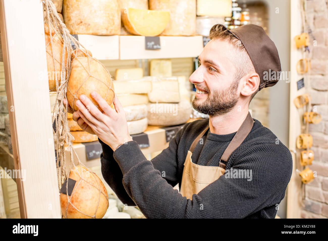 Cheese seller at the shop Stock Photo - Alamy