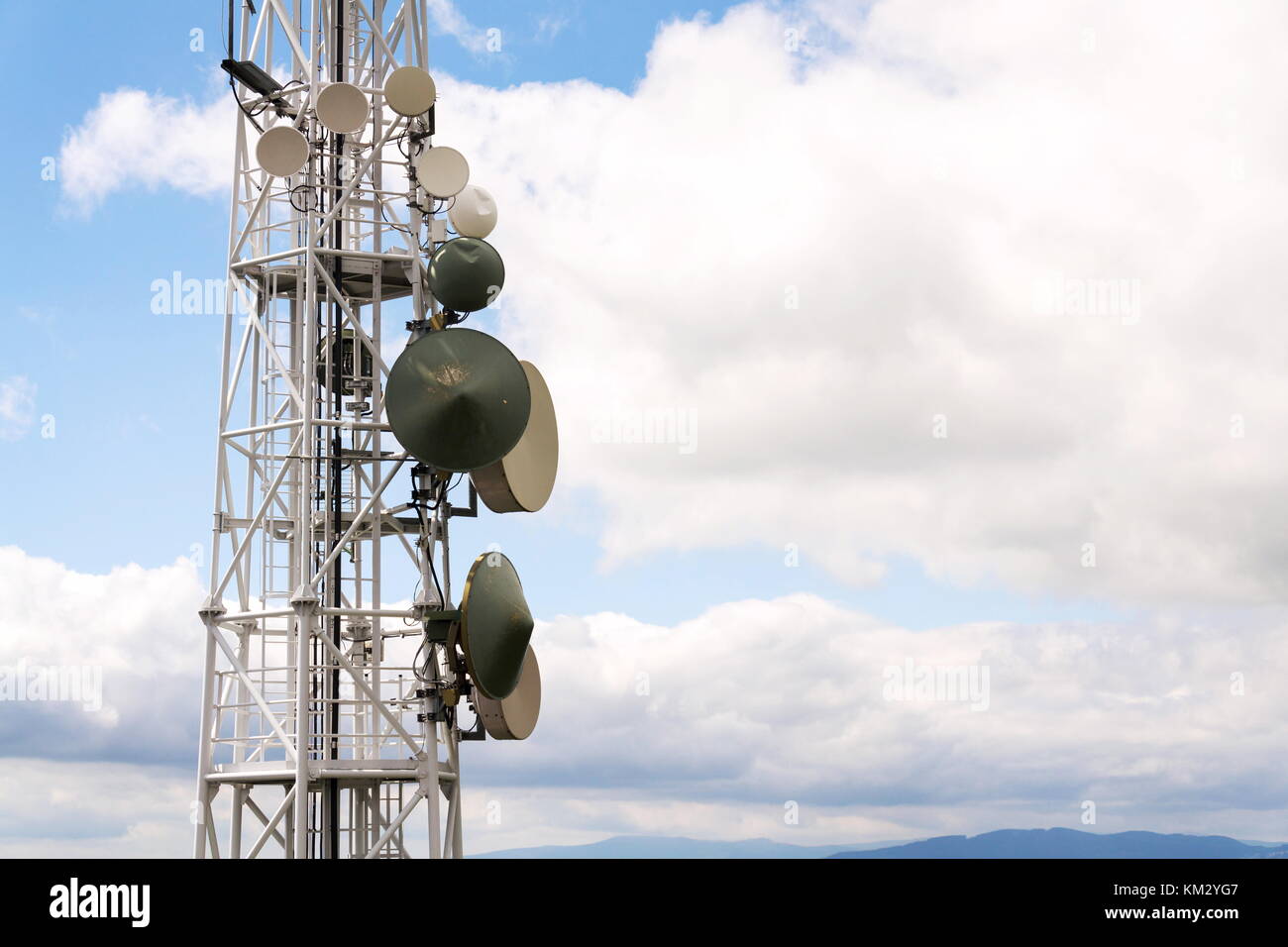 Transmitters and aerials on telecommunication tower with cloudy blue sky Stock Photo - Alamy