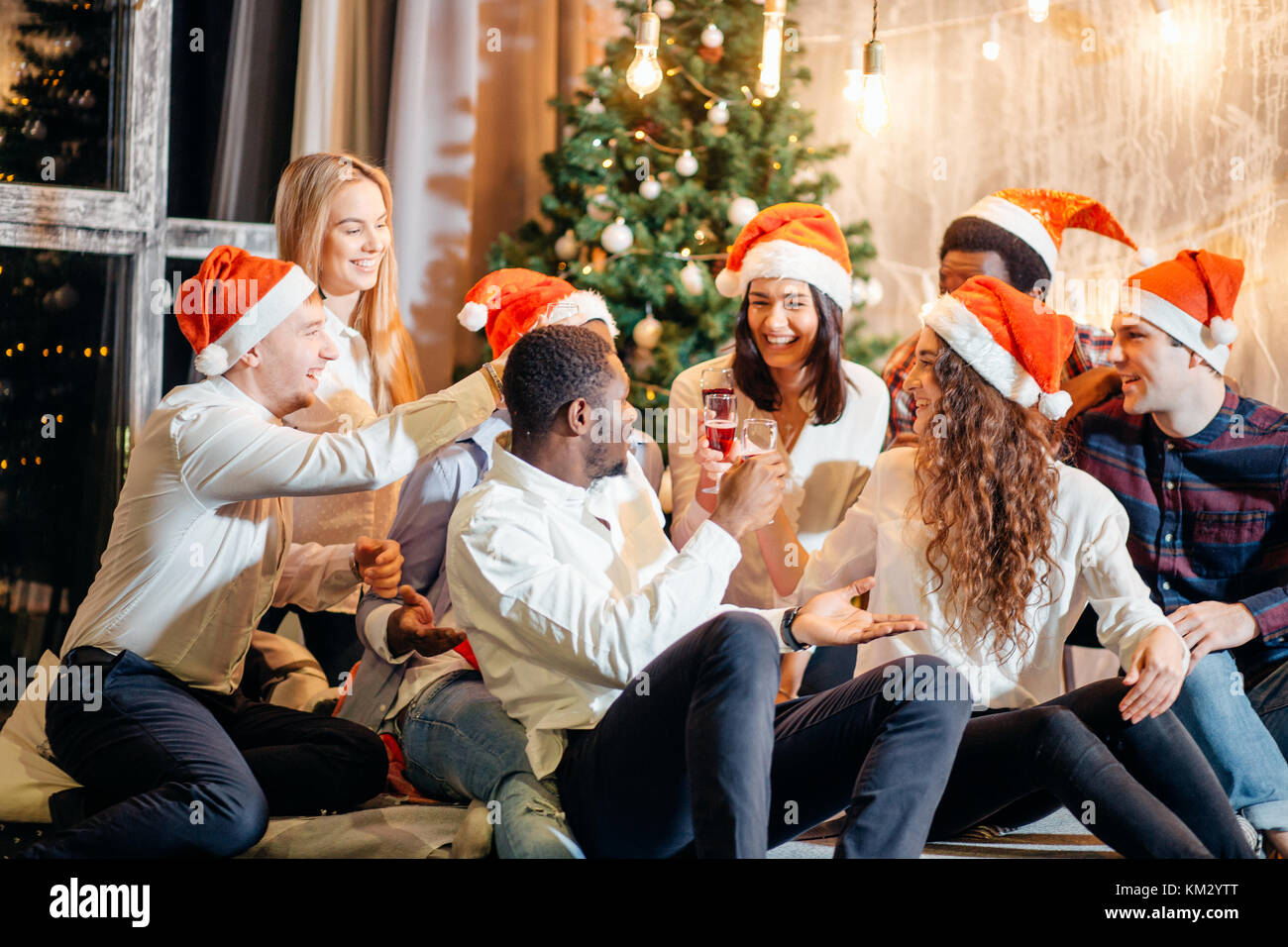 Christmas party friends at having drink and fun Stock Photo - Alamy