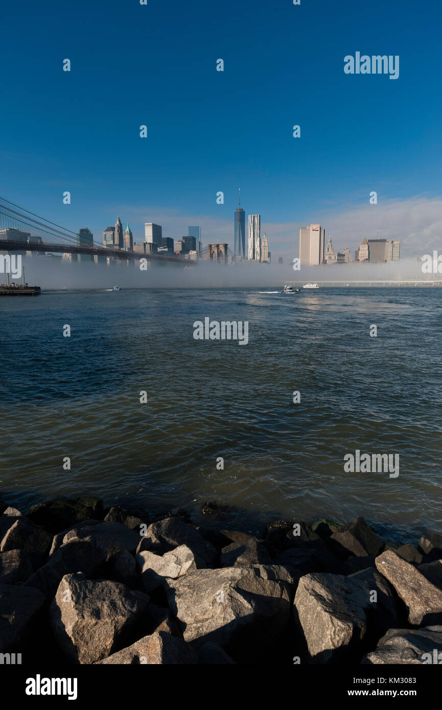 Brooklyn bridge and New York City skyline in the morning mist, New York ...
