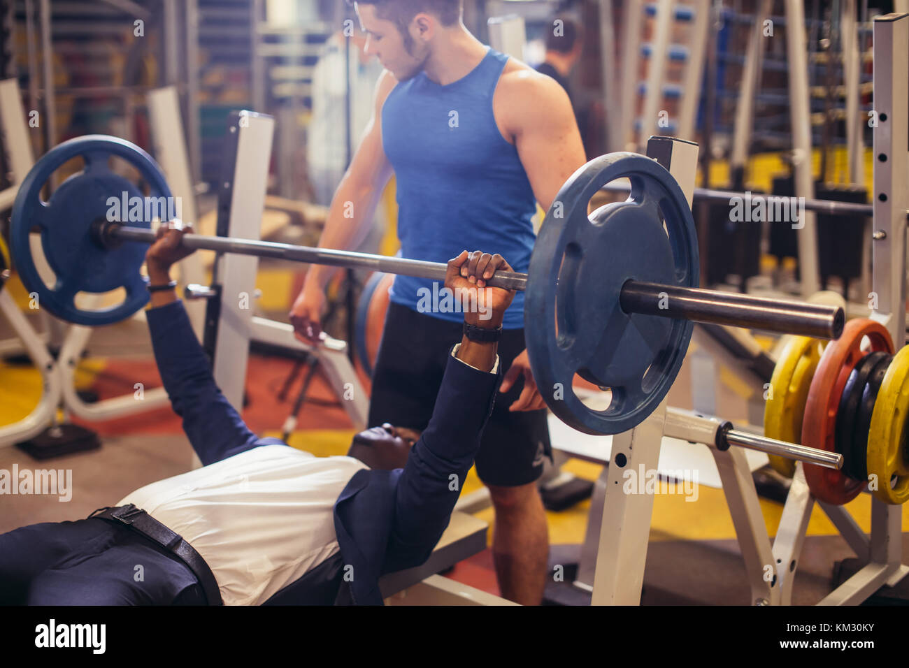 People bench pressing gym and working out Stock Photo - Alamy