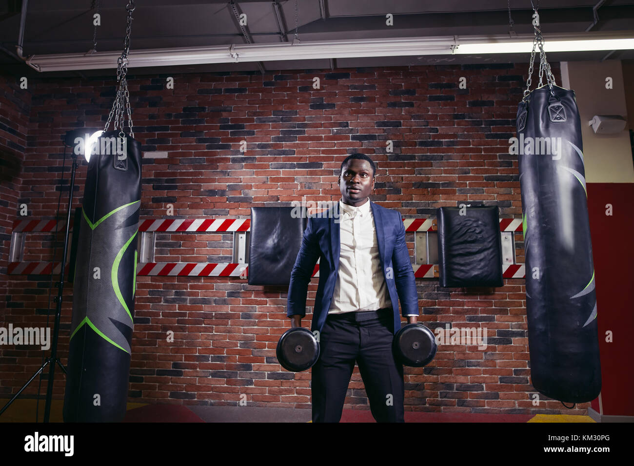 African fitness model exercising with heavy dumbbells Stock Photo - Alamy