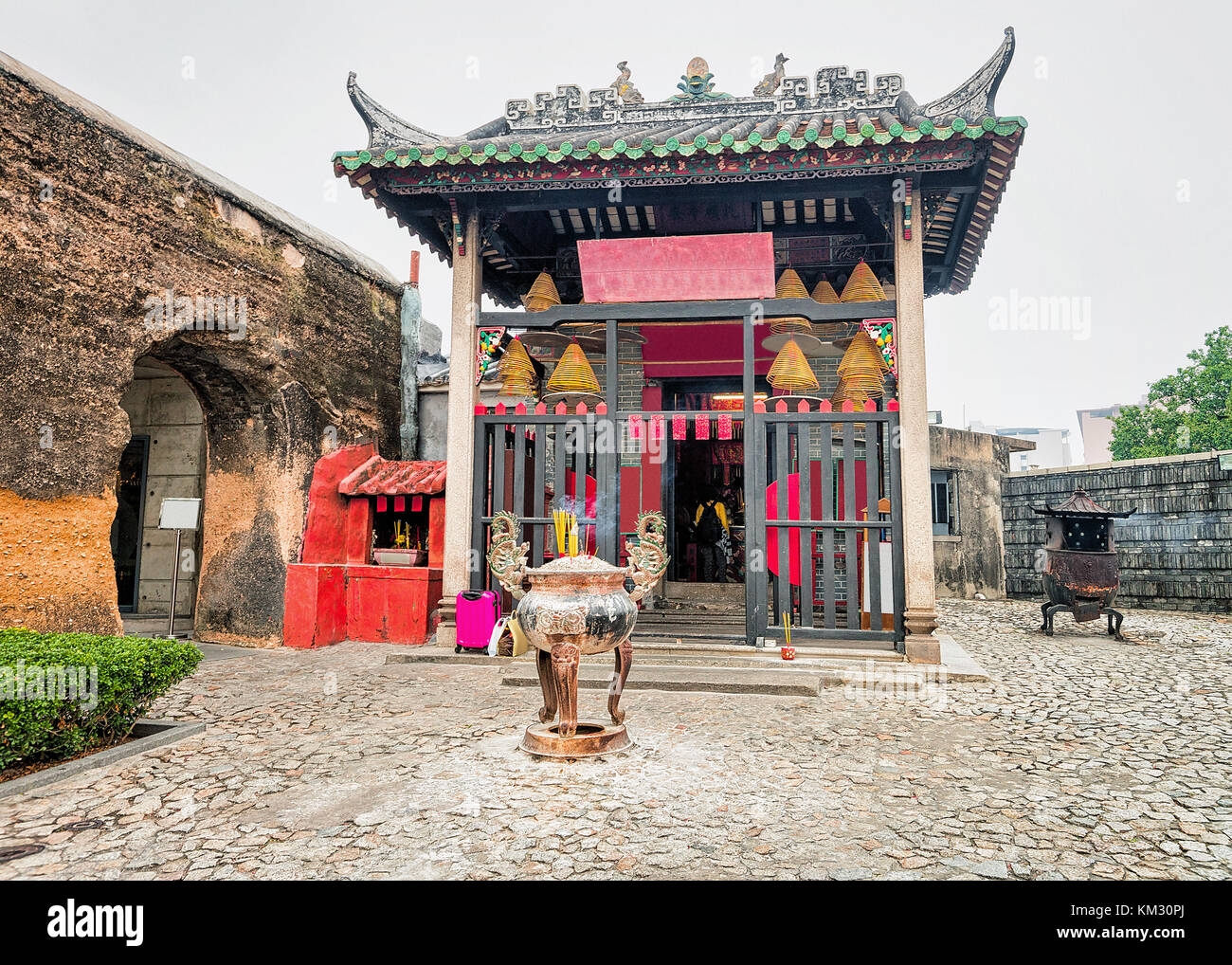 Na Tcha Temple in Historical old city center in Macao, China. People on ...