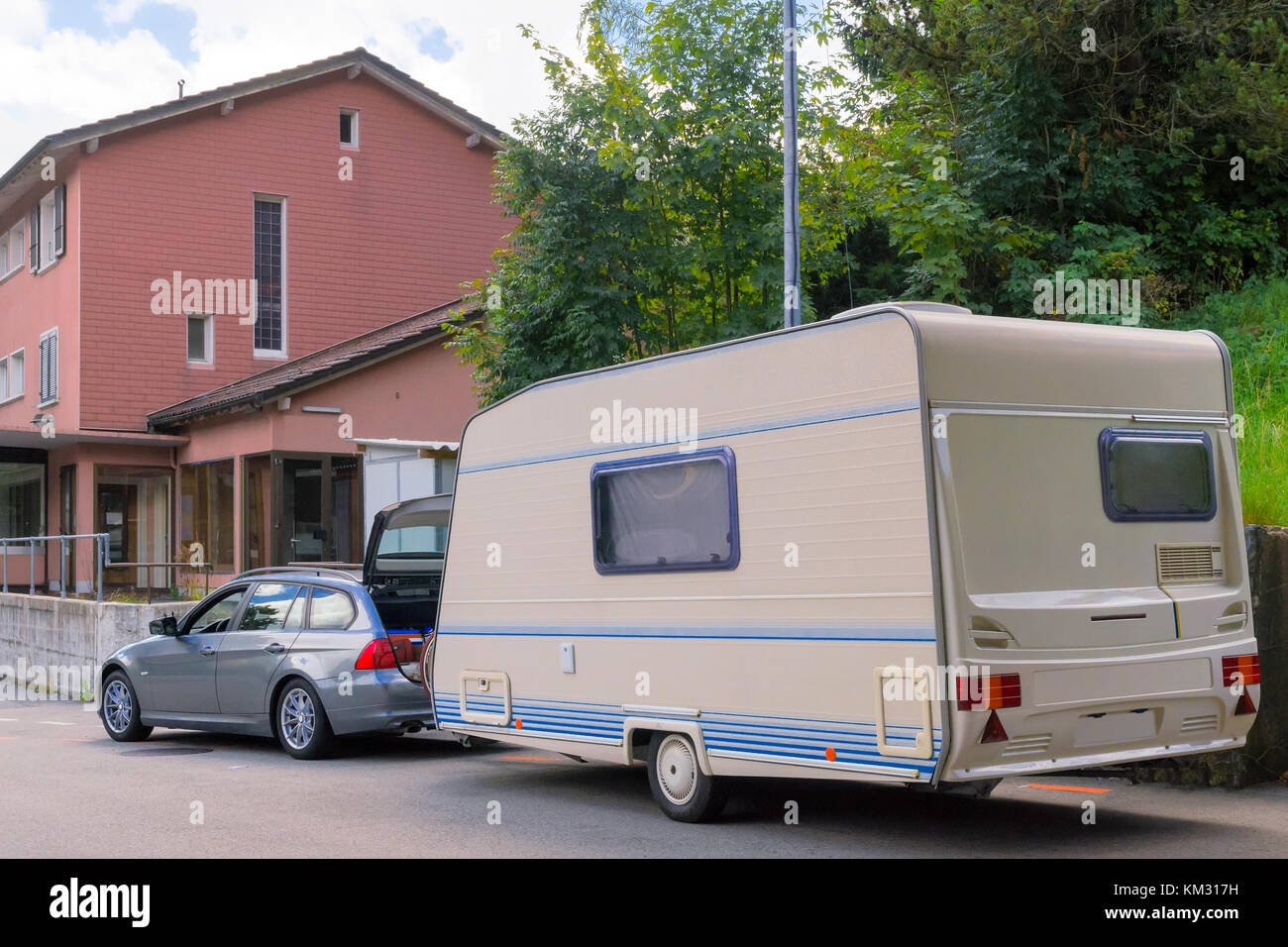 Car with caravan on the road in Switzerland Stock Photo - Alamy