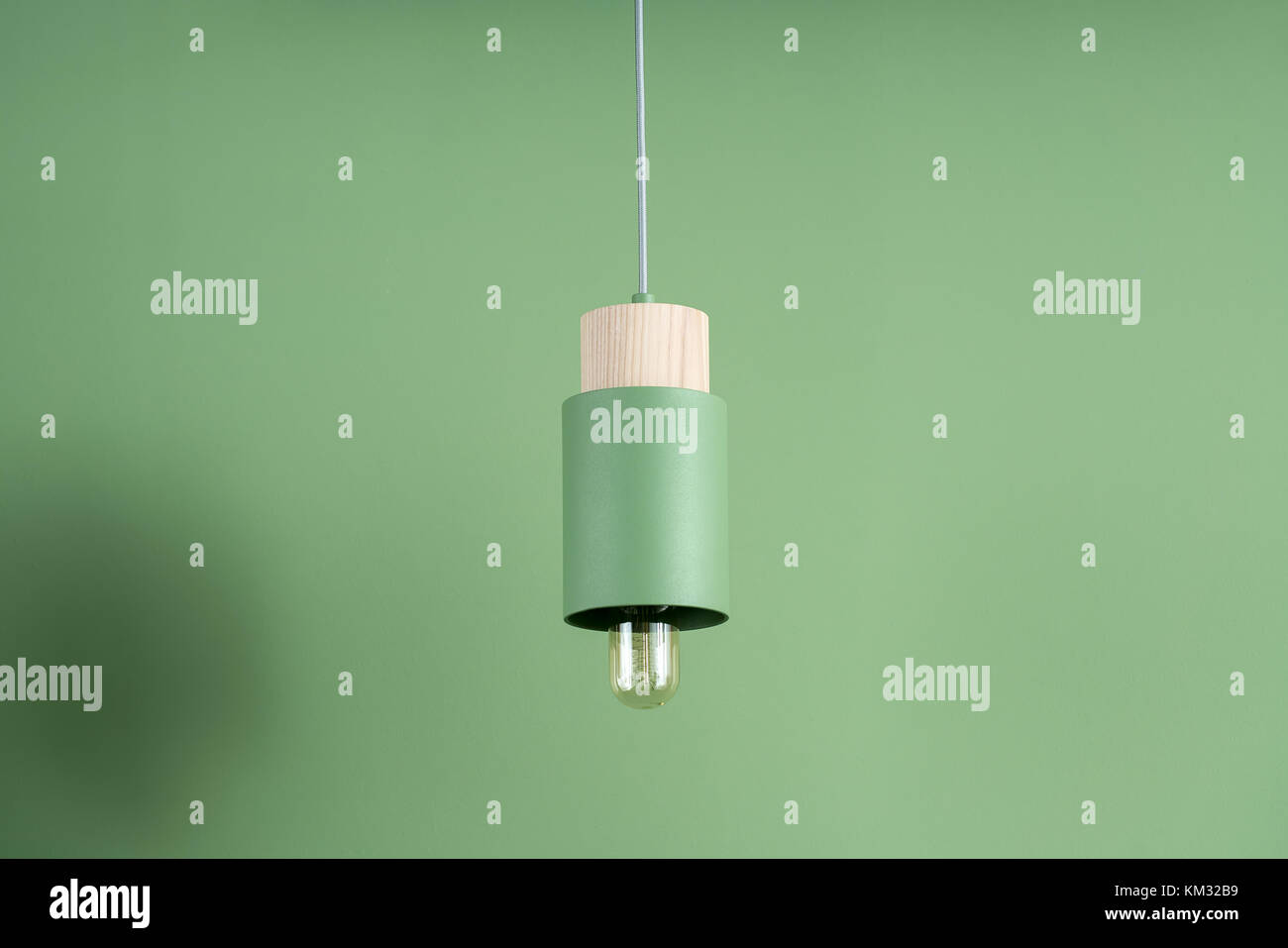 Hanging metal green edison lamp with wooden part Stock Photo - Alamy