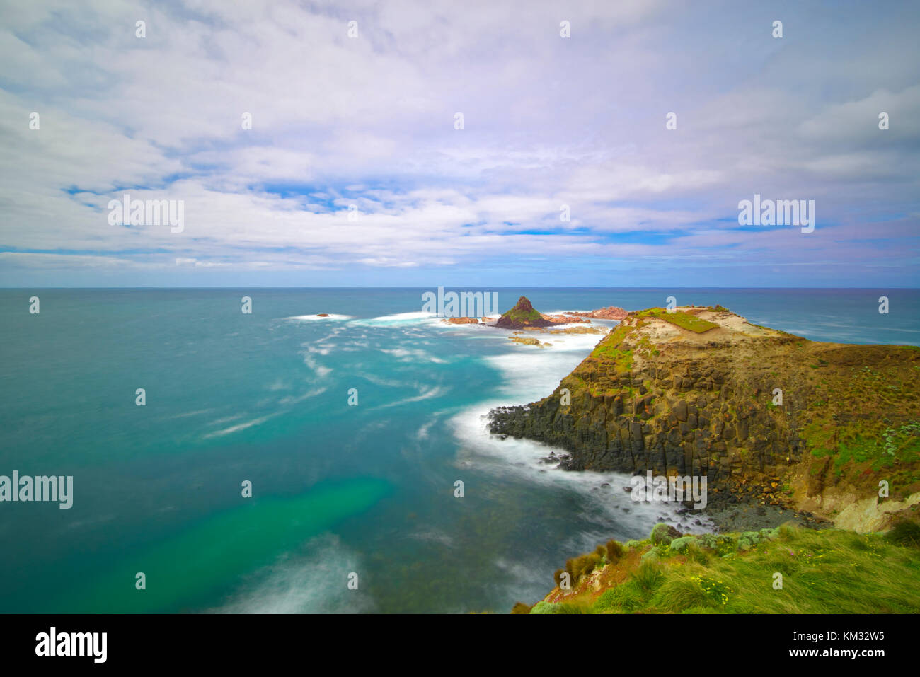 Rocky Coast Line With Pyramid Shaped Island Stock Photo - Alamy