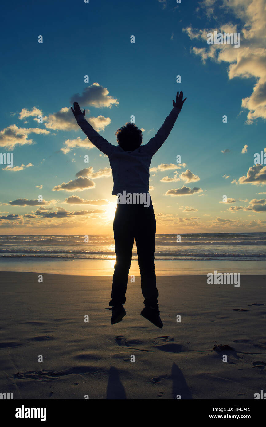 Kid jumping back view hi-res stock photography and images - Alamy