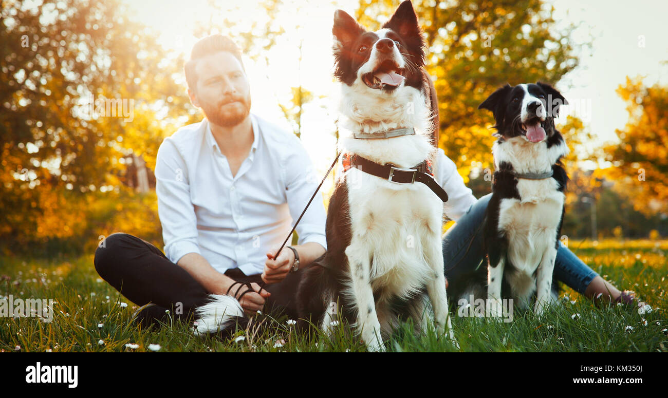 Romantic couple in love walking dogs in nature and smiling Stock Photo ...