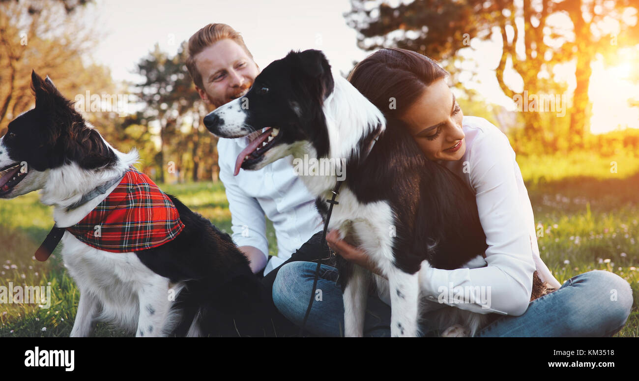 Romantic couple in love walking dogs in nature and smiling Stock Photo ...