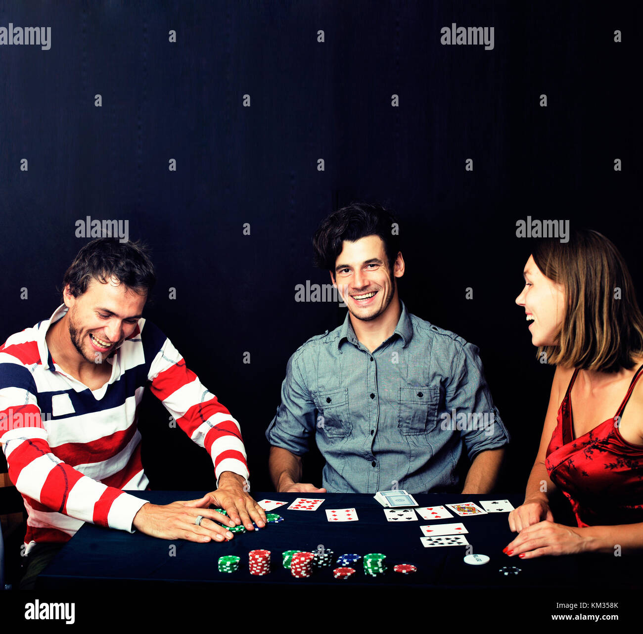young people playing poker on black background Stock Photo - Alamy
