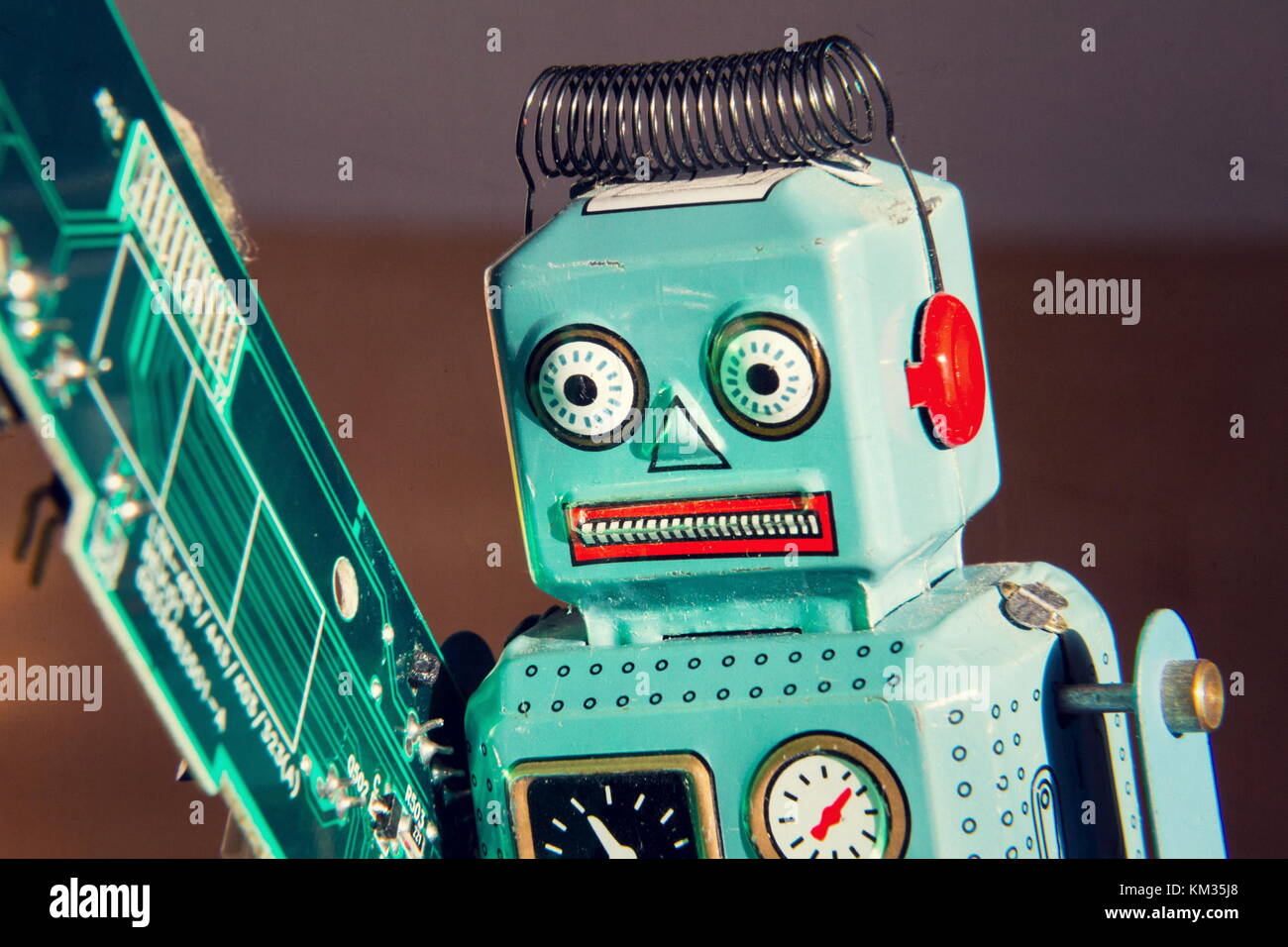 Tin toy robot carries computer circuit board, artificial intelligence ...