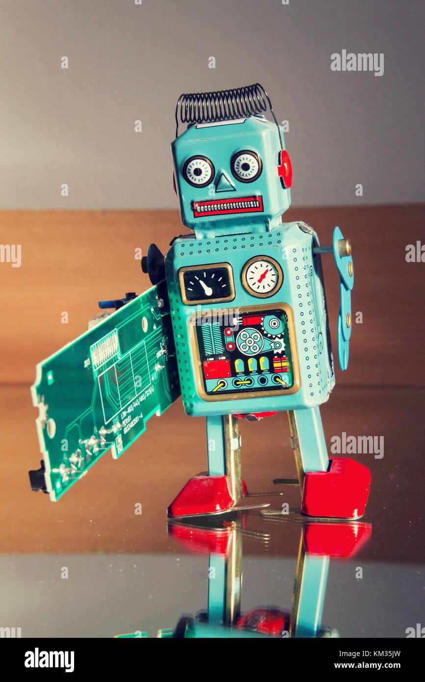 Tin toy robot carries computer circuit board, artificial intelligence ...