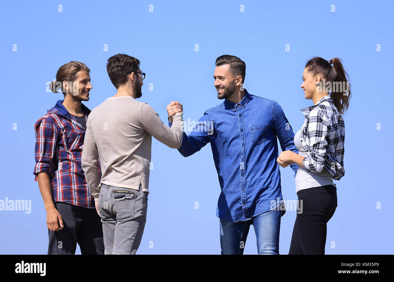 friends greet each other with a handshake Stock Photo - Alamy