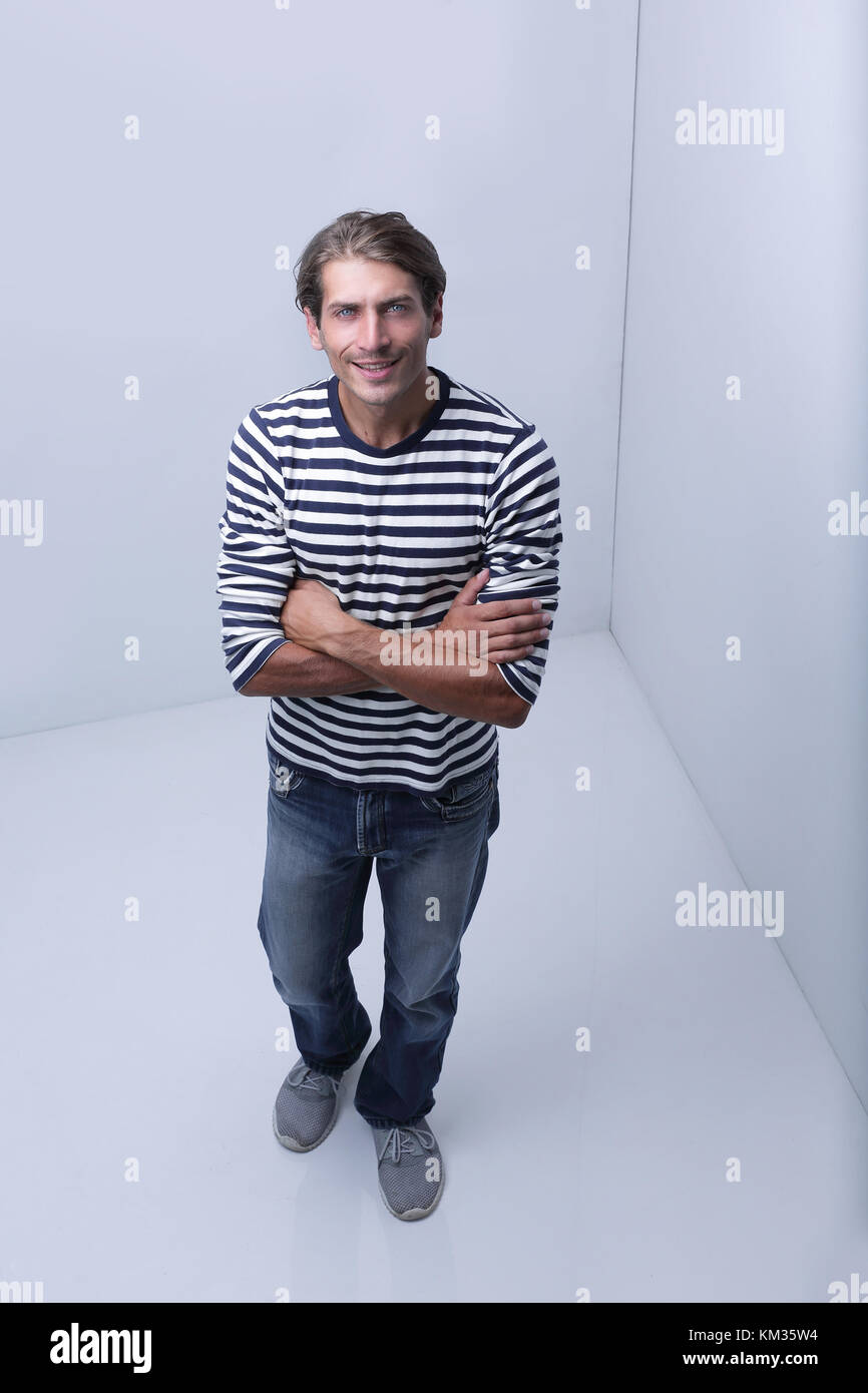 modern man standing in the corner of the white room Stock Photo - Alamy