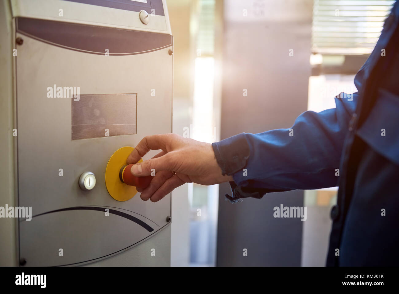 Man is rotating a red switch Stock Photo - Alamy