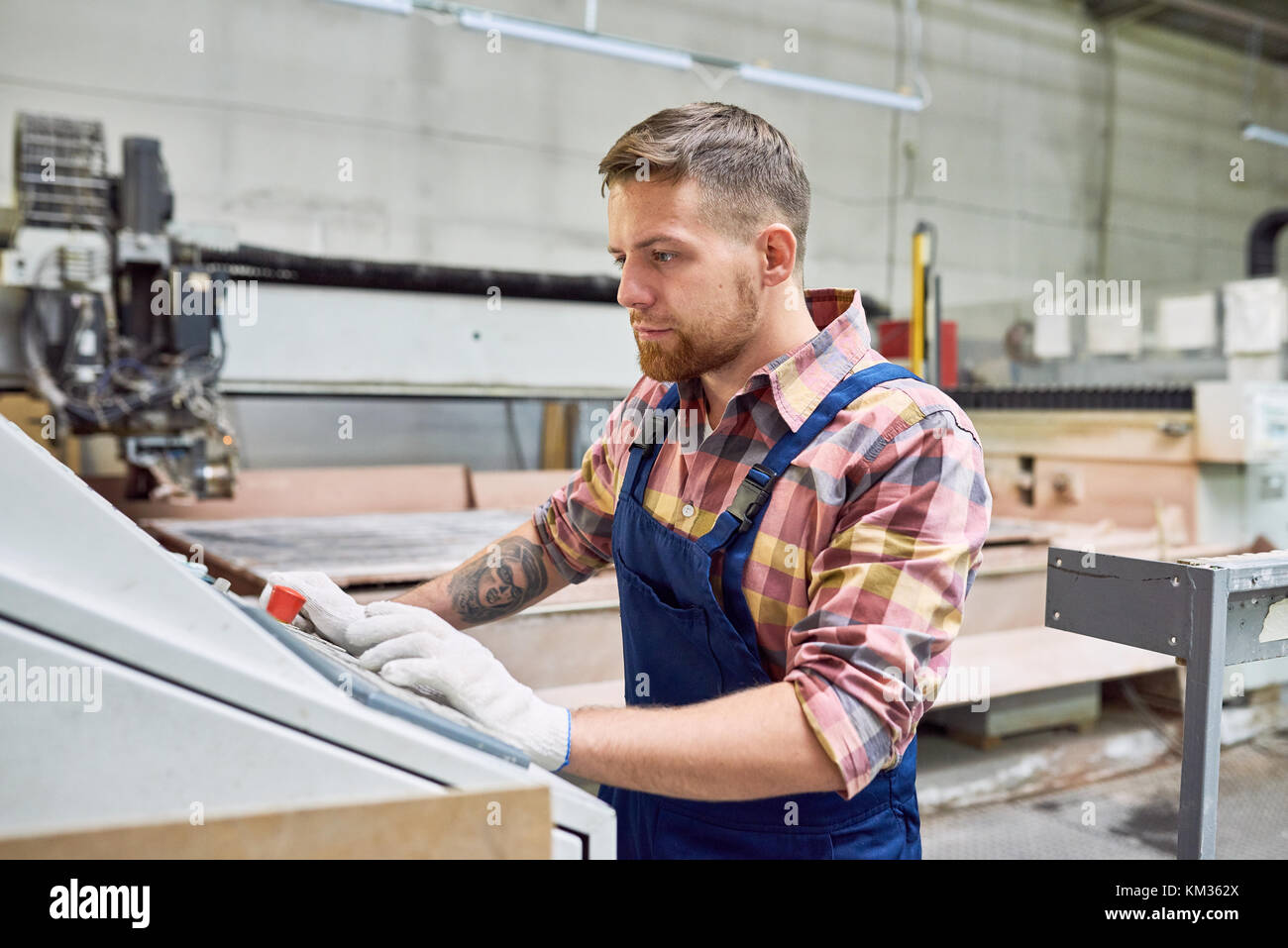 Young Man Operating Units at Factory Stock Photo - Alamy