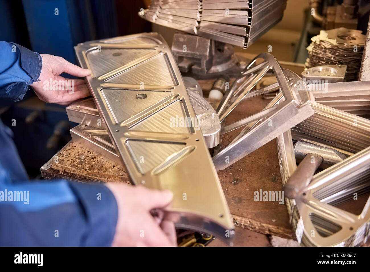 Hands of engineer, metal part Stock Photo - Alamy