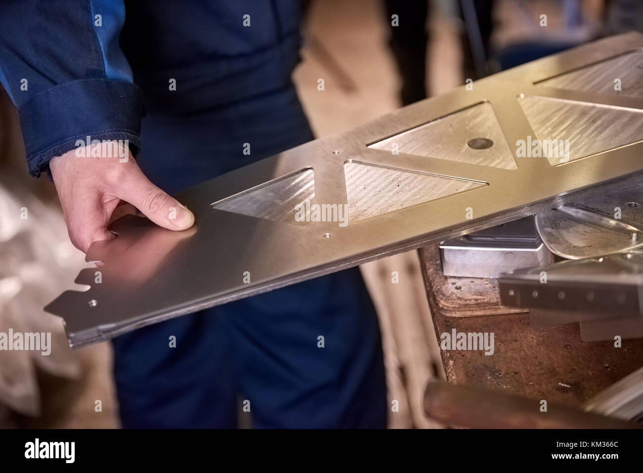 Hand holding metal part Stock Photo - Alamy