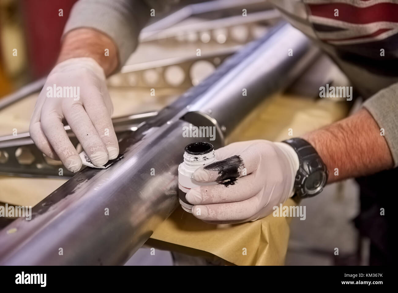 Hand applies primer on steel Stock Photo - Alamy