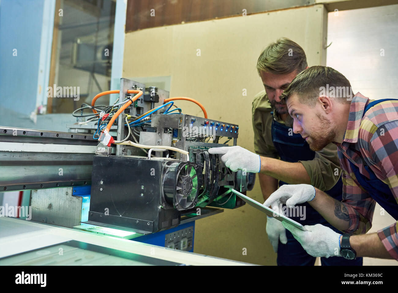 Mechanics Fixing Machine at Factory Stock Photo - Alamy