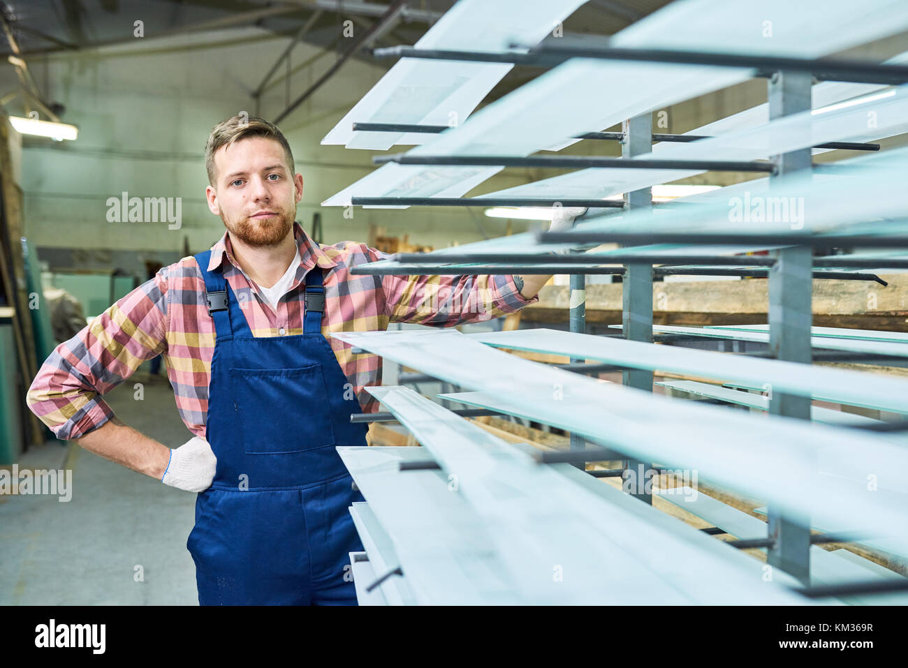Young Factory Worker Posing in Workshop Stock Photo - Alamy