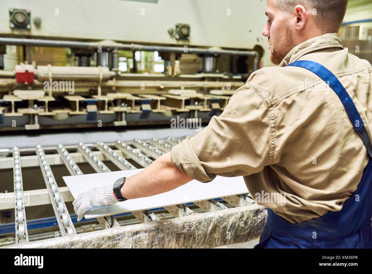 Young Man Working at Modern Factory Stock Photo - Alamy
